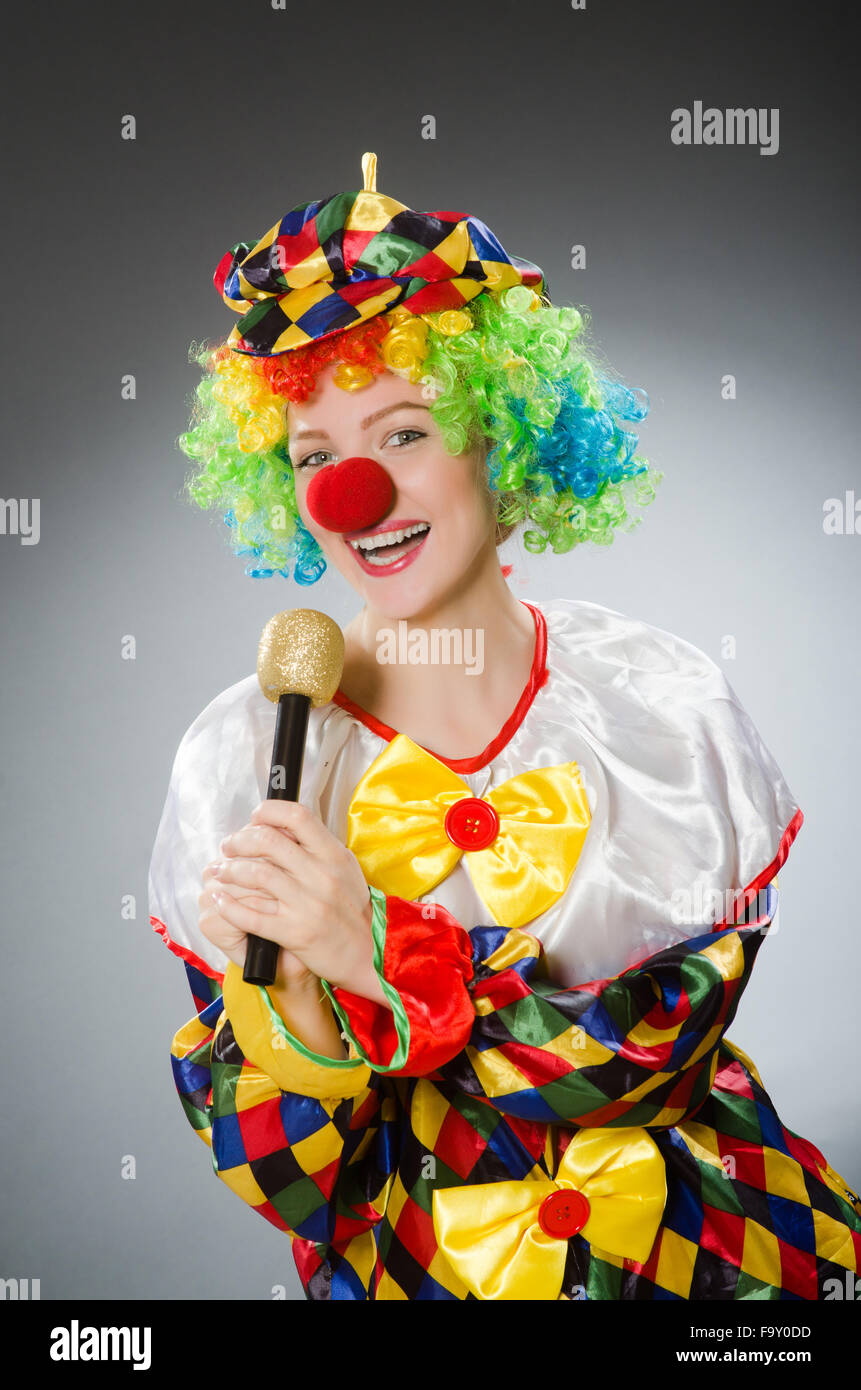 Clown with mic in funny concept Stock Photo - Alamy