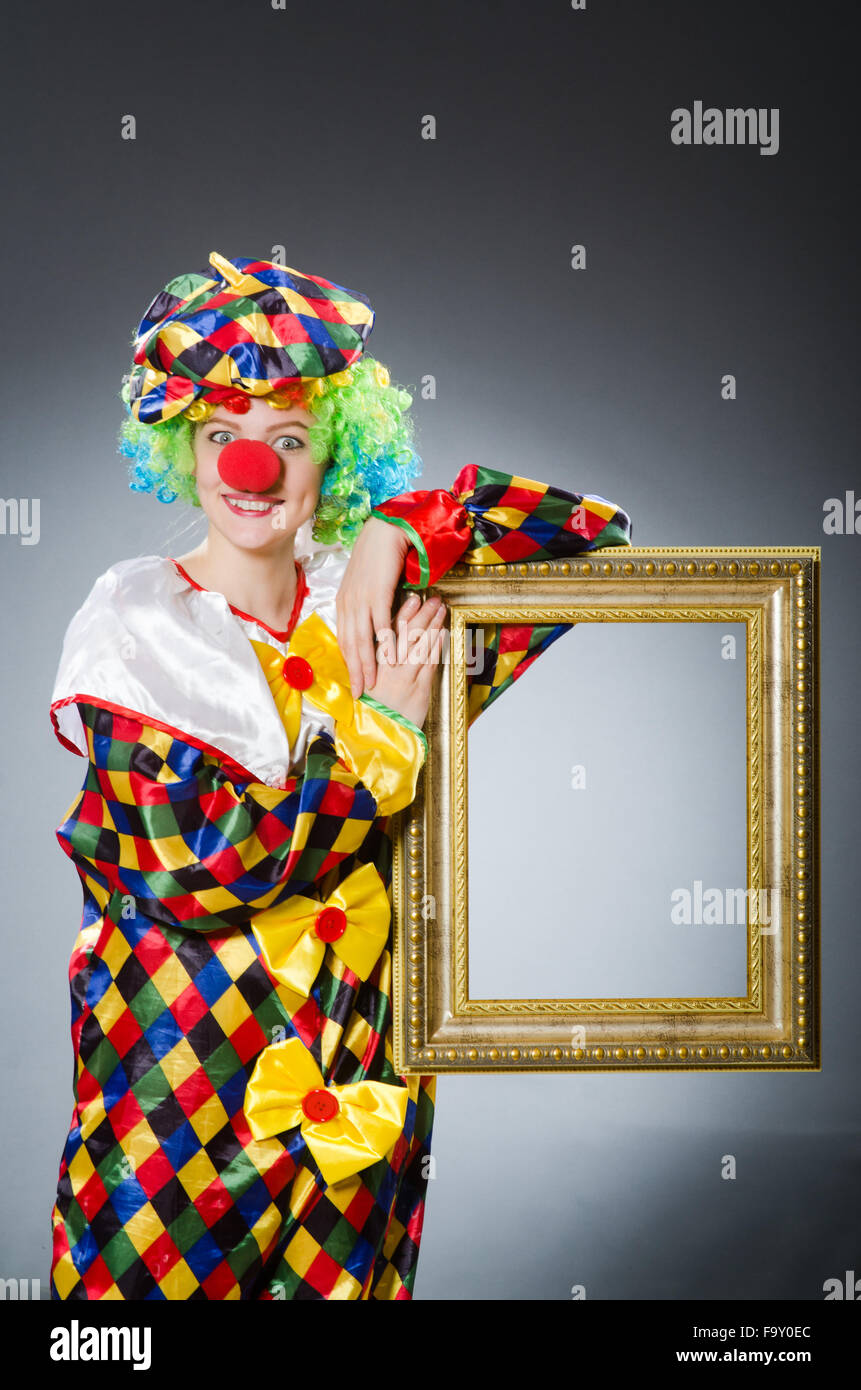 Clown with picture frame in funny concept Stock Photo - Alamy