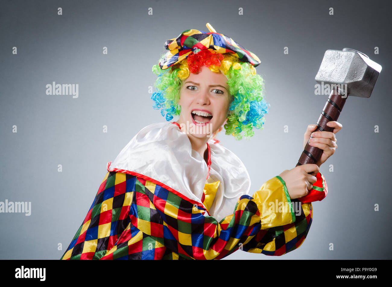 Clown with hammer in funny concept Stock Photo - Alamy