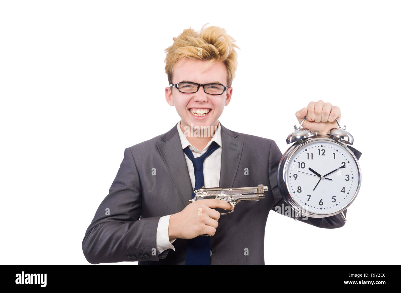 Young businessman holidng gun and alarm clock isolated on white Stock ...