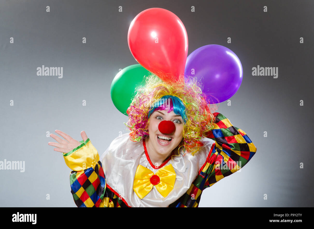 Clown with balloons in funny concept Stock Photo - Alamy