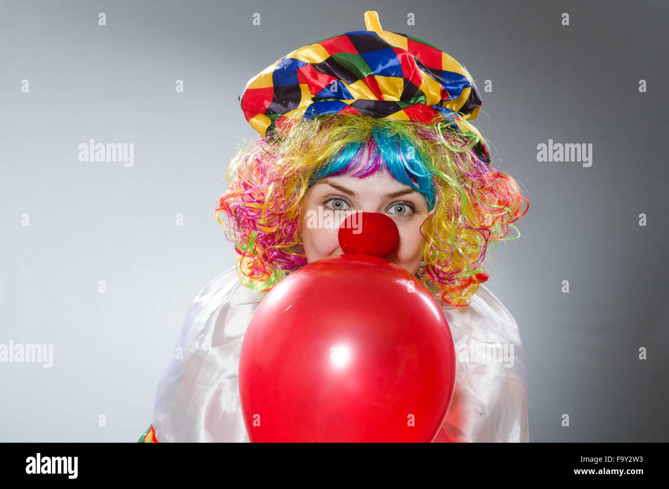 Clown with balloons in funny concept Stock Photo - Alamy