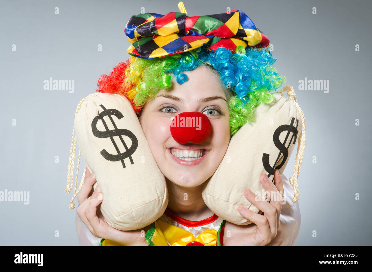 Clown with money bag in funny concept Stock Photo - Alamy