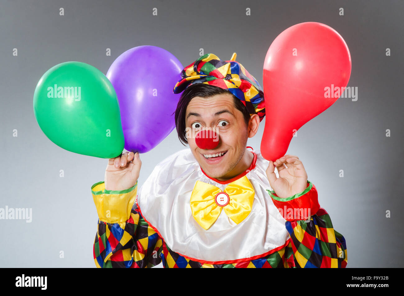 Clown with balloons in funny concept Stock Photo - Alamy