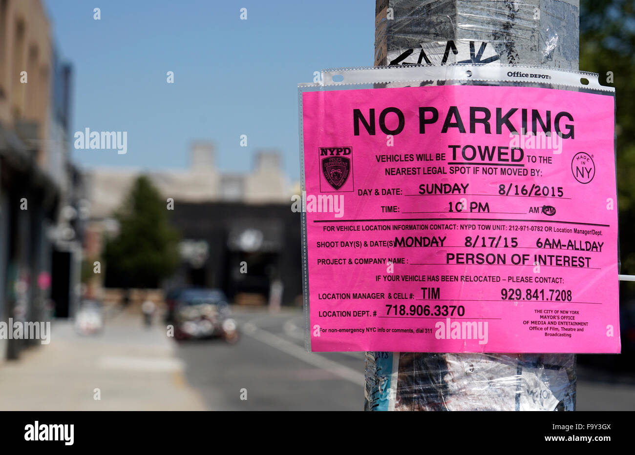 Parking warning note by local police on a street light pole ...