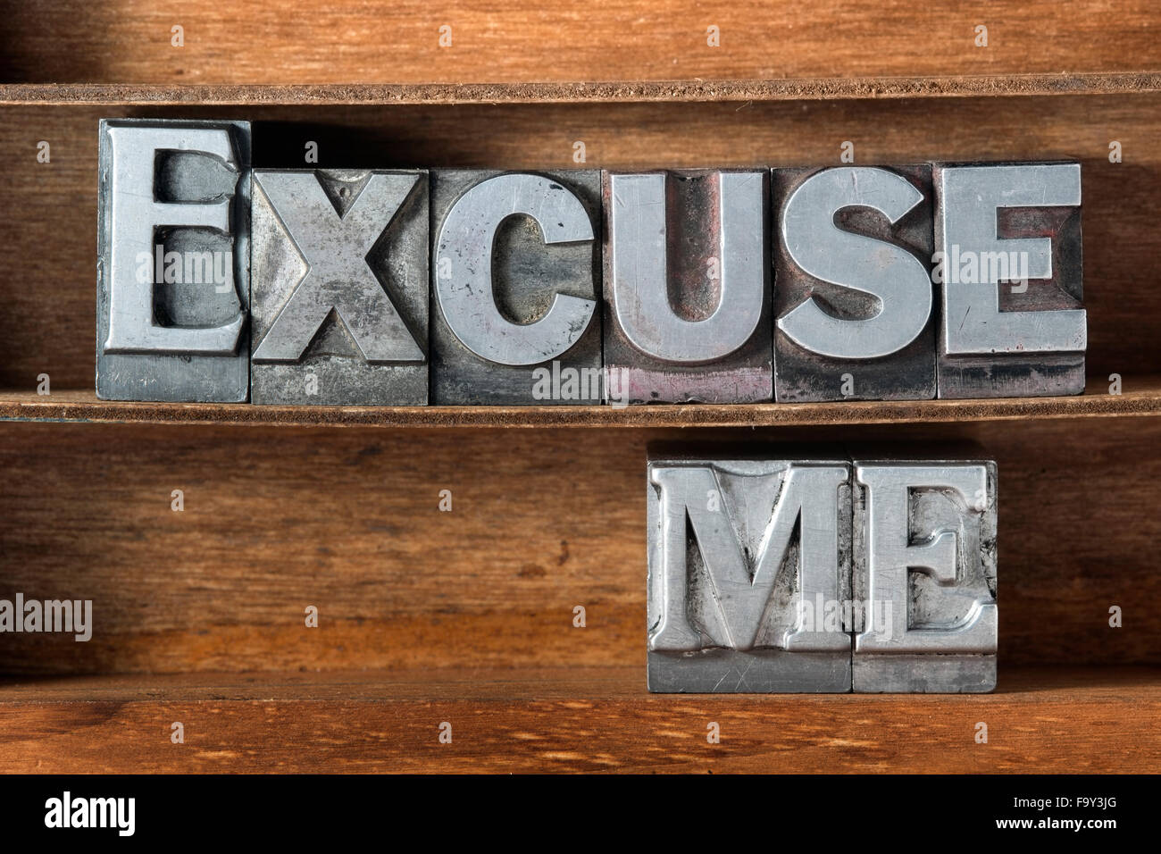 excuse me phrase made from metallic letterpress type on wooden tray ...