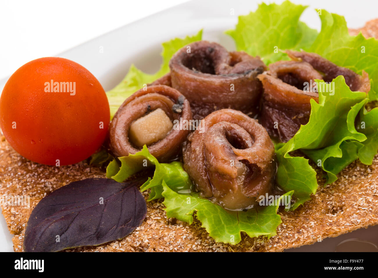 Anchovy snack with salad and tomato Stock Photo - Alamy