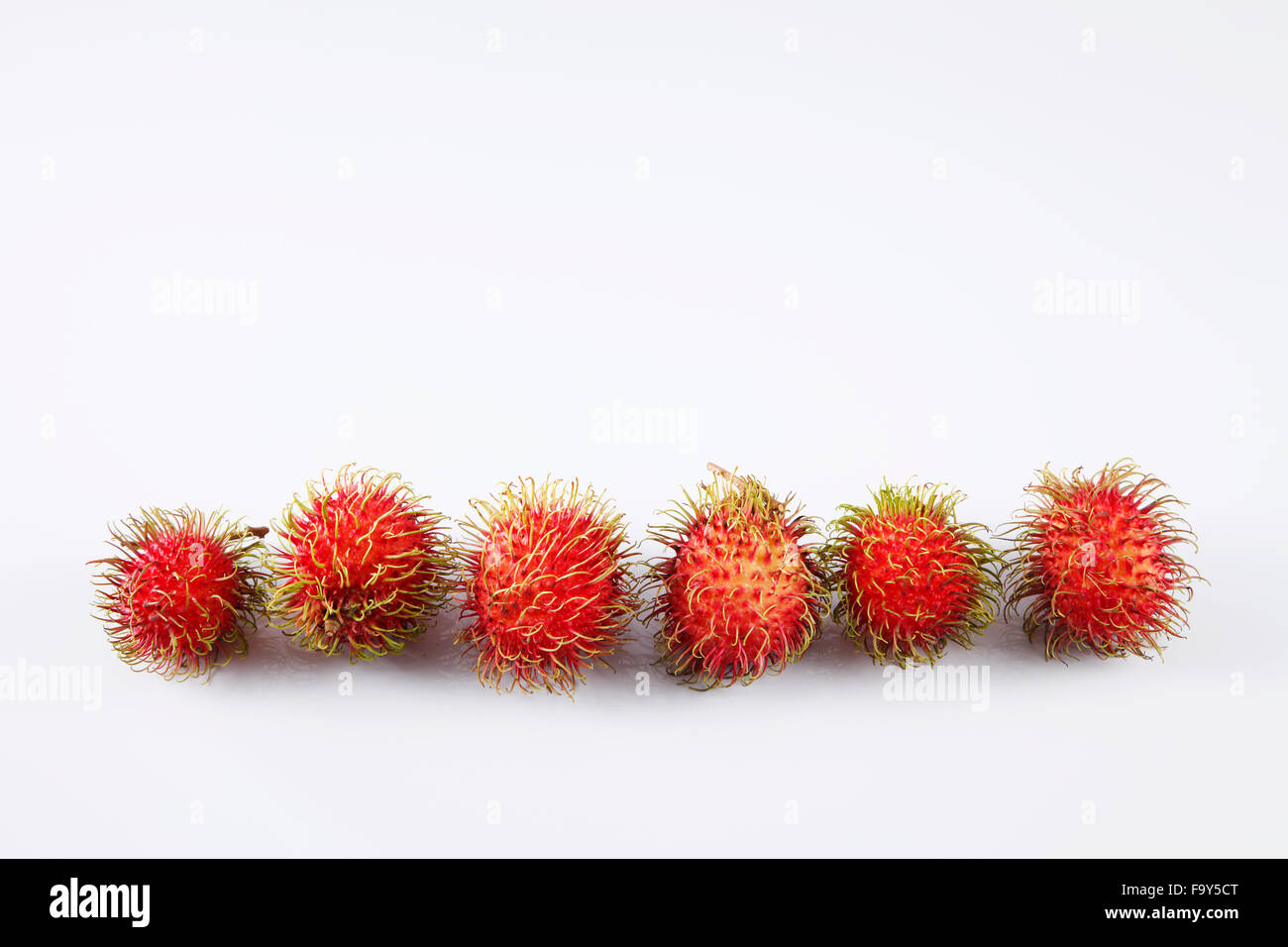 asian fruit rambutan on the plain background Stock Photo - Alamy