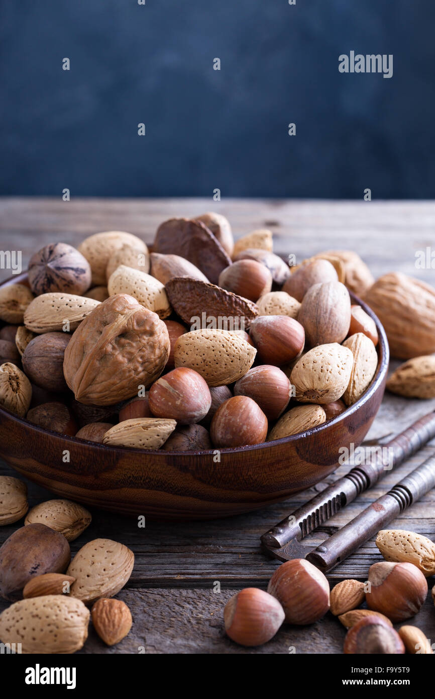 Variety of nuts with shells in a brown bowl Stock Photo - Alamy