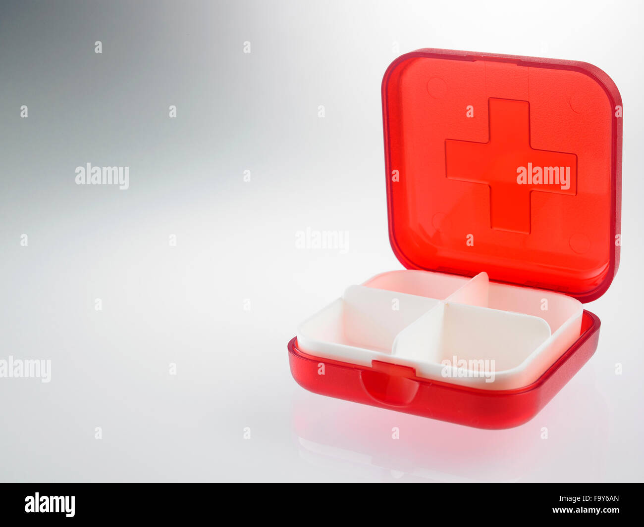 empty red pill box on the white background Stock Photo - Alamy