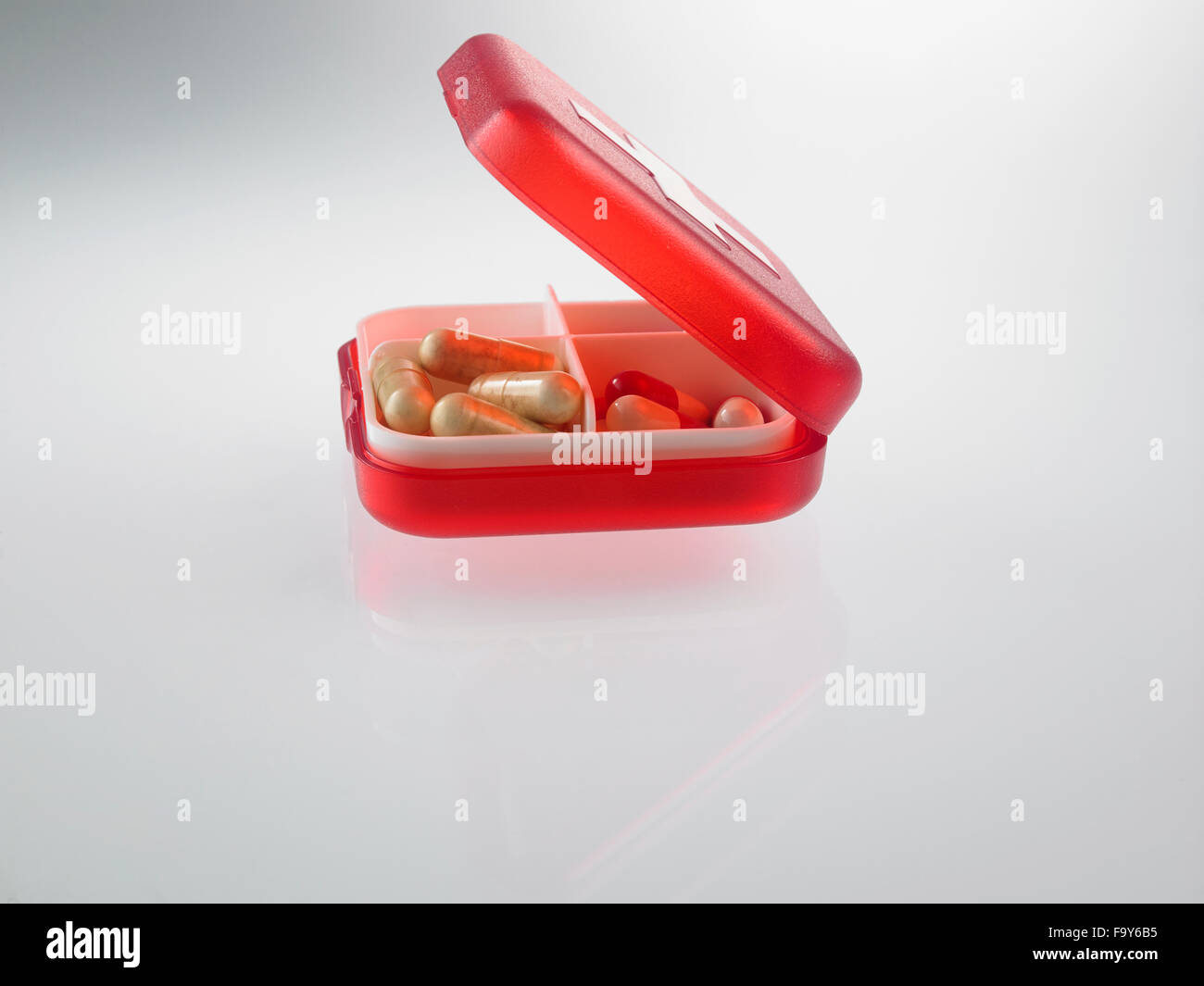 red pill box with medicine Stock Photo - Alamy
