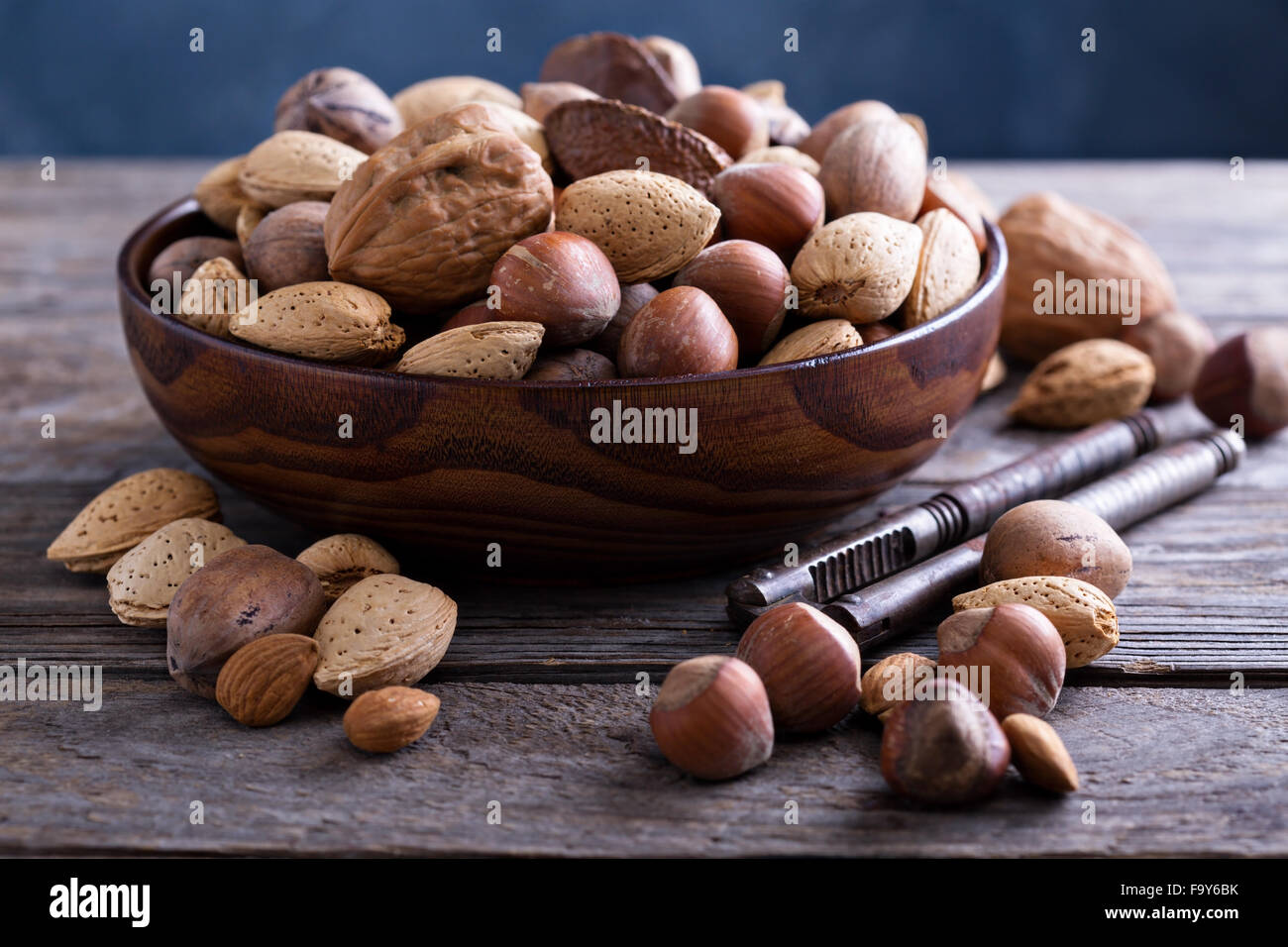 Variety of nuts with shells in a brown bowl Stock Photo - Alamy