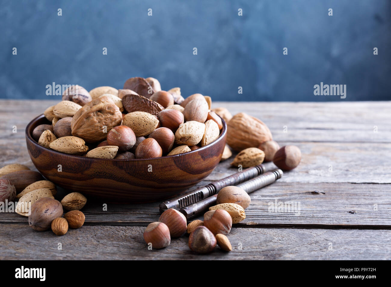 Variety of nuts with shells in a brown bowl Stock Photo - Alamy