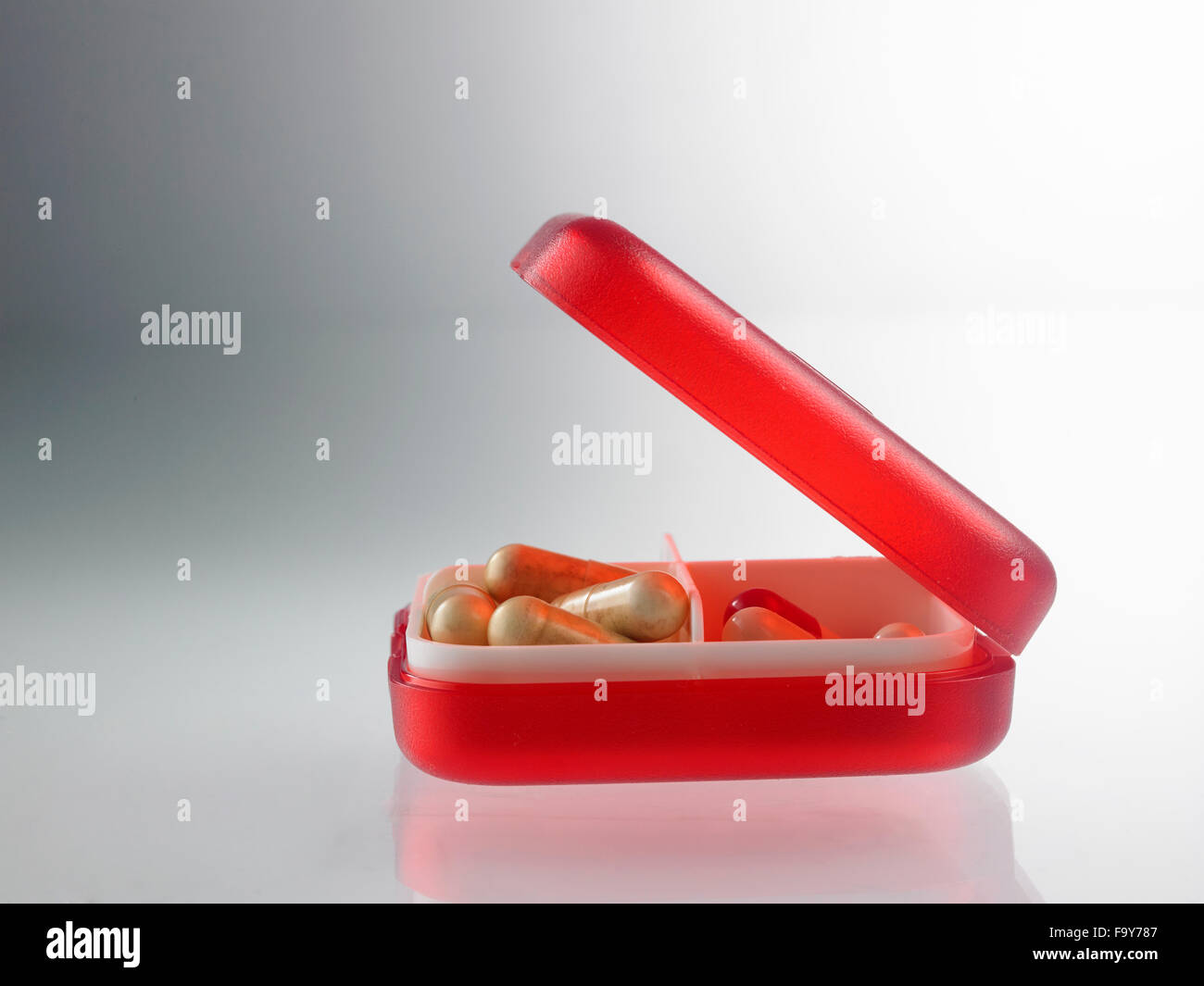 red pill box with medicine Stock Photo - Alamy