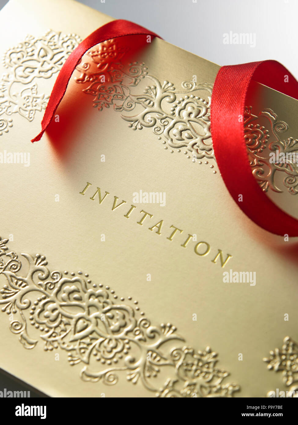 golden invitation card with ribbon Stock Photo - Alamy