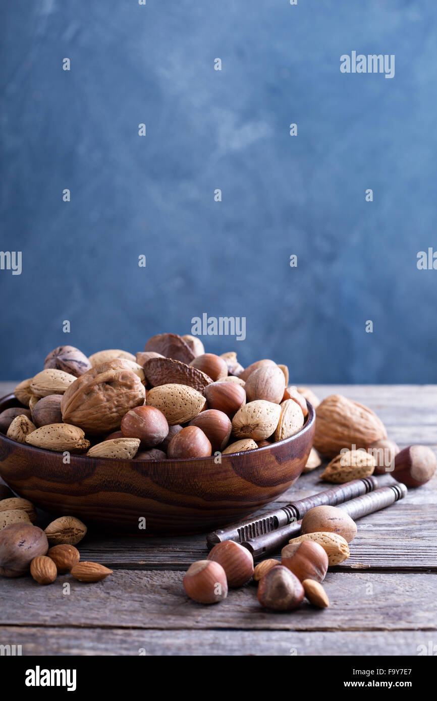 Variety of nuts with shells in a brown bowl Stock Photo - Alamy