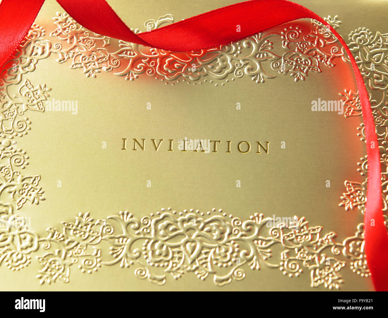 golden invitation card with ribbon Stock Photo - Alamy