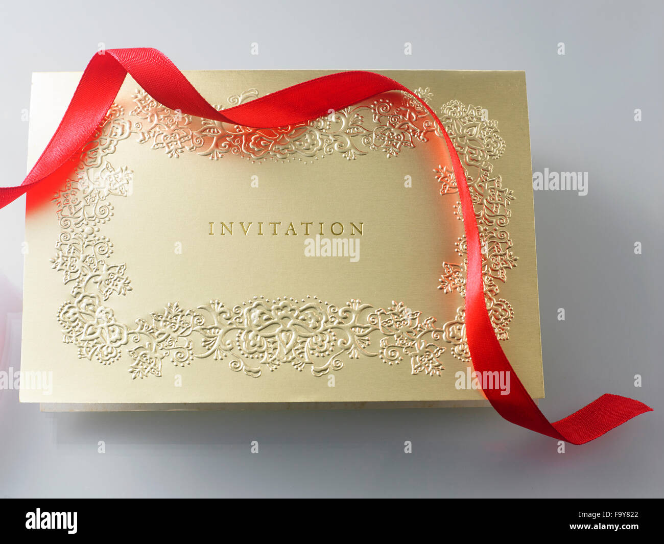 golden invitation card with ribbon Stock Photo - Alamy