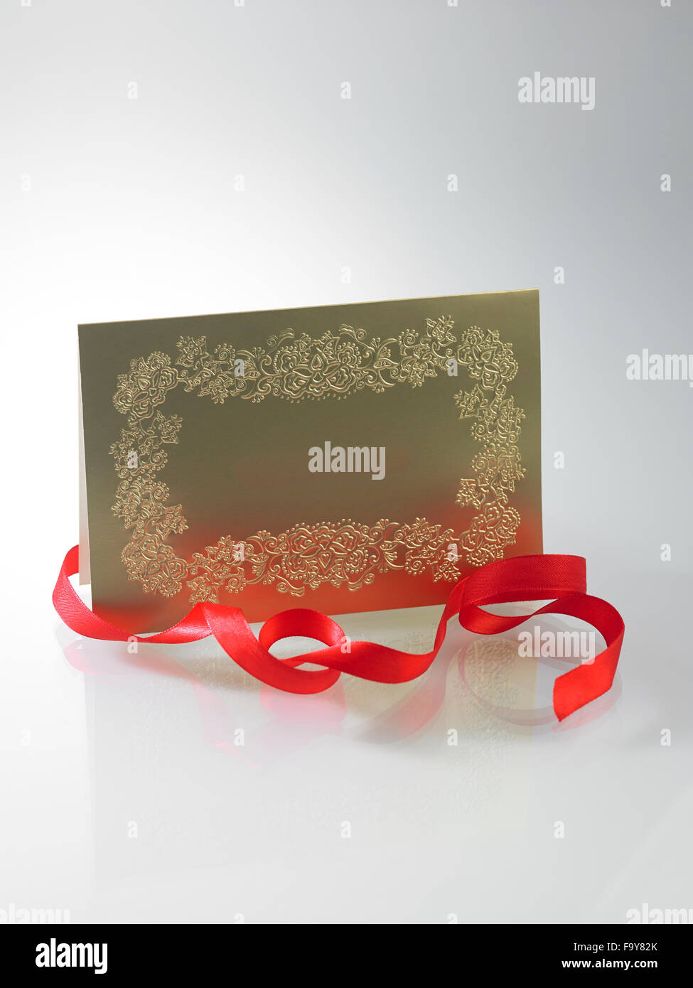 golden invitation card with ribbon Stock Photo - Alamy