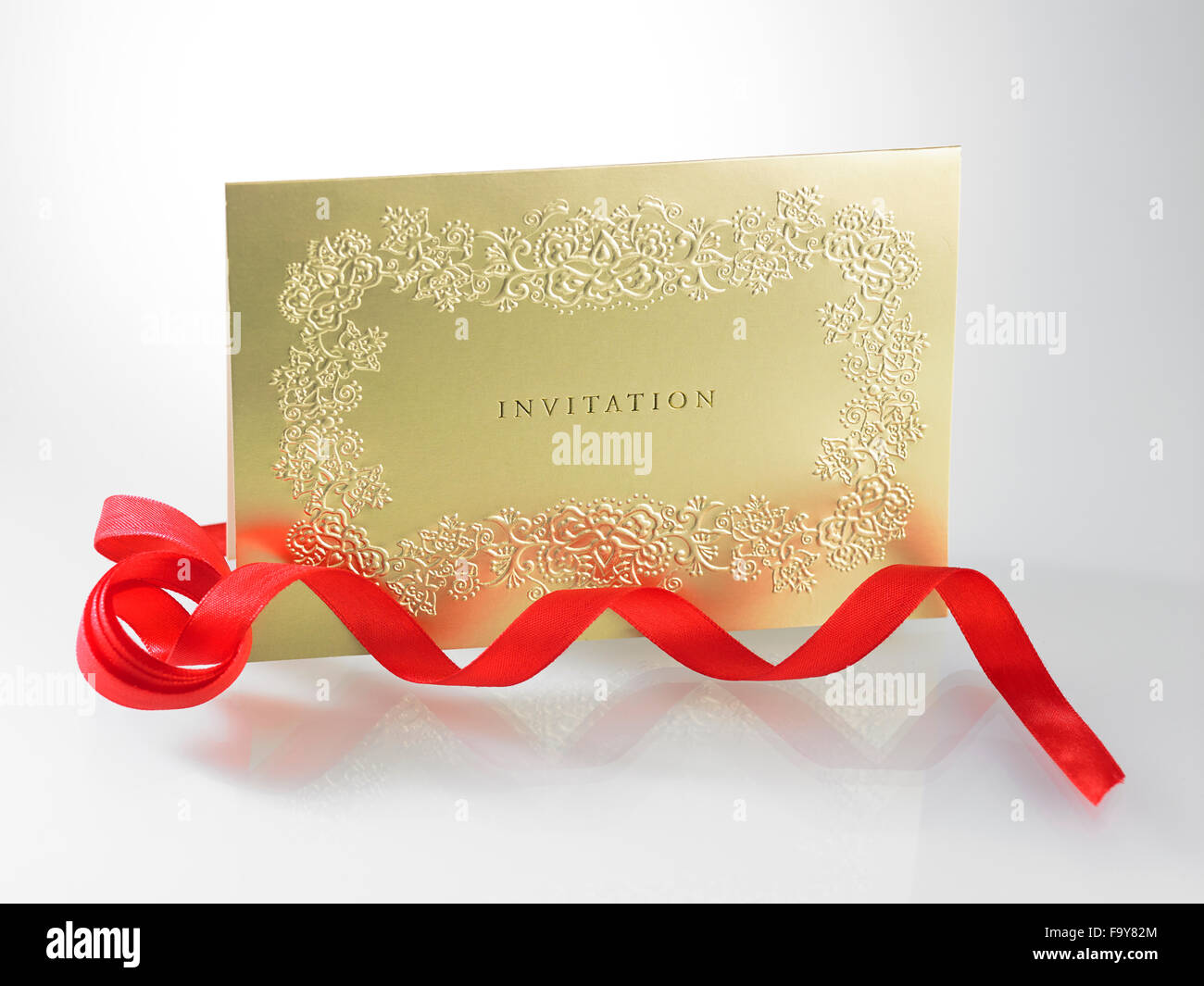 golden invitation card with ribbon Stock Photo - Alamy