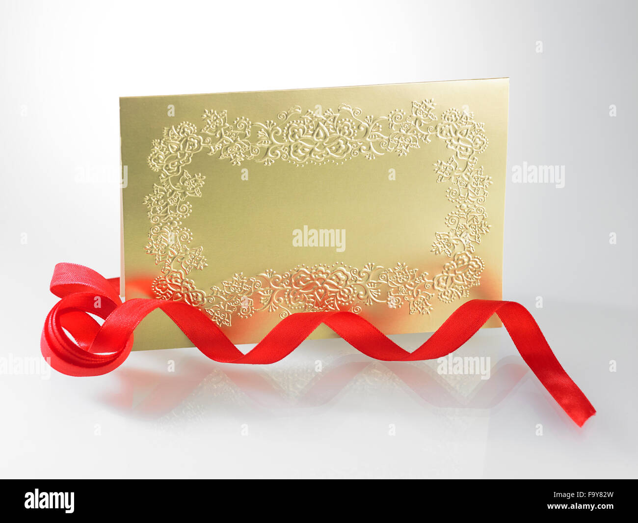golden invitation card with ribbon Stock Photo - Alamy