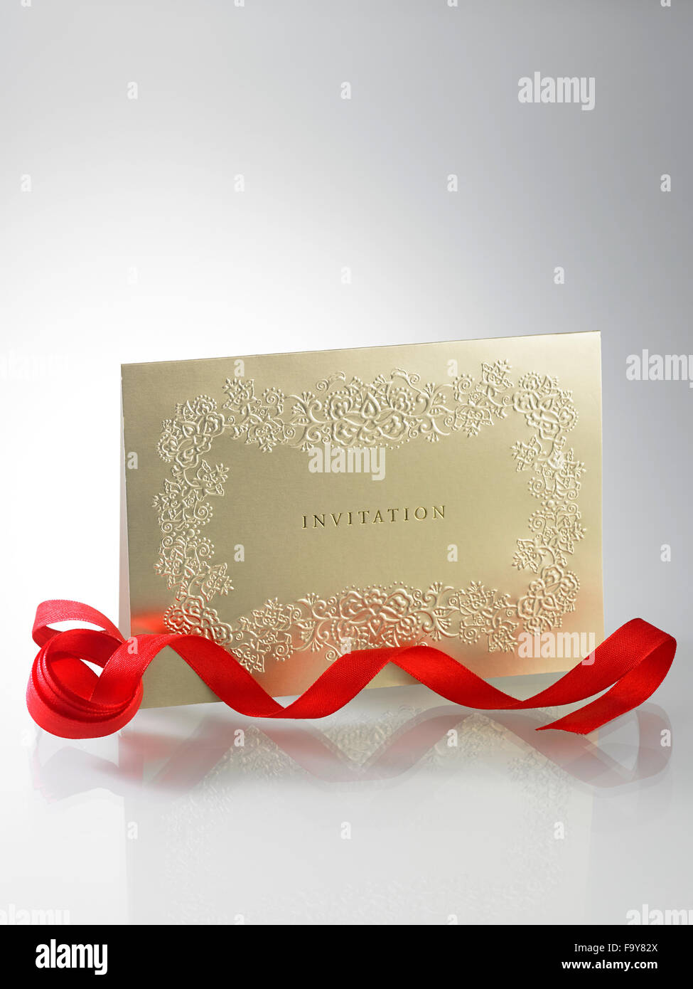 golden invitation card with ribbon Stock Photo - Alamy
