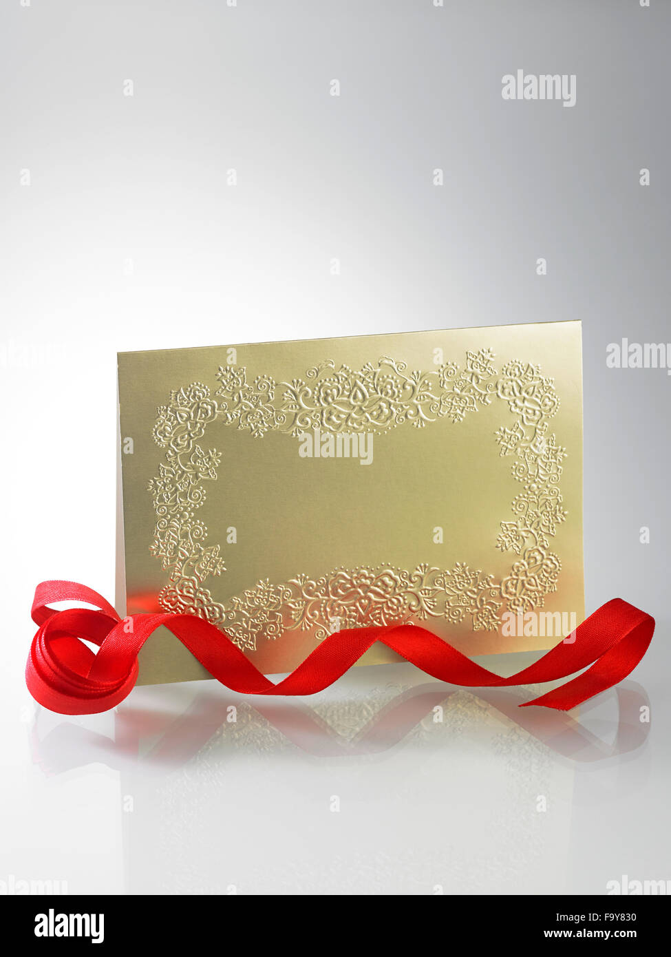 golden invitation card with ribbon Stock Photo - Alamy