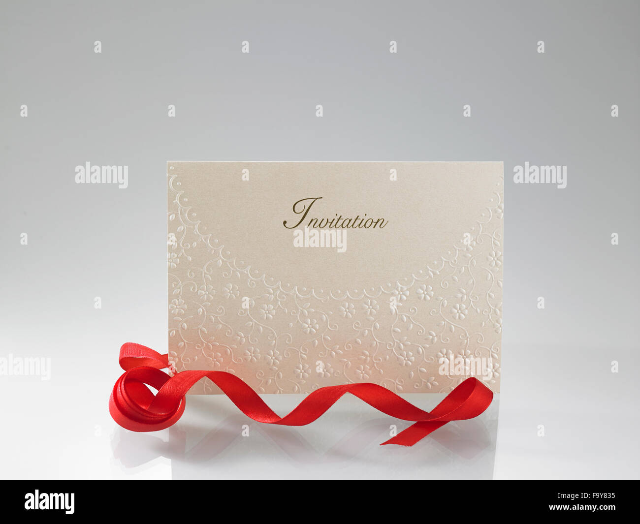 golden invitation card with ribbon Stock Photo - Alamy