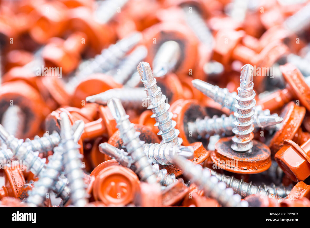 Many screws arranged as background Stock Photo - Alamy