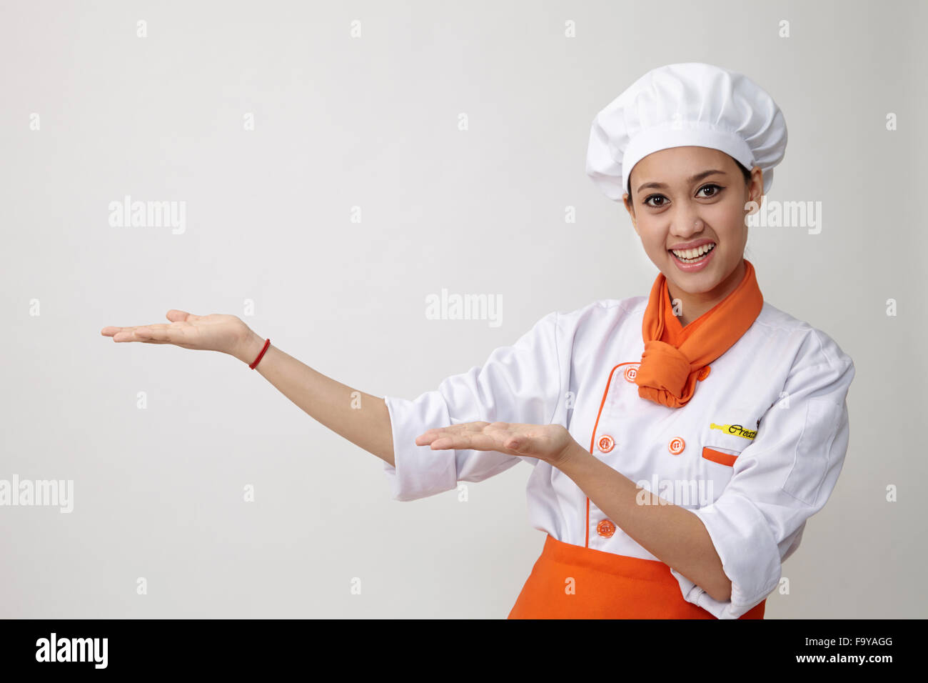 Portrait of young graceful woman dressed as a cook with cap Stock Photo ...