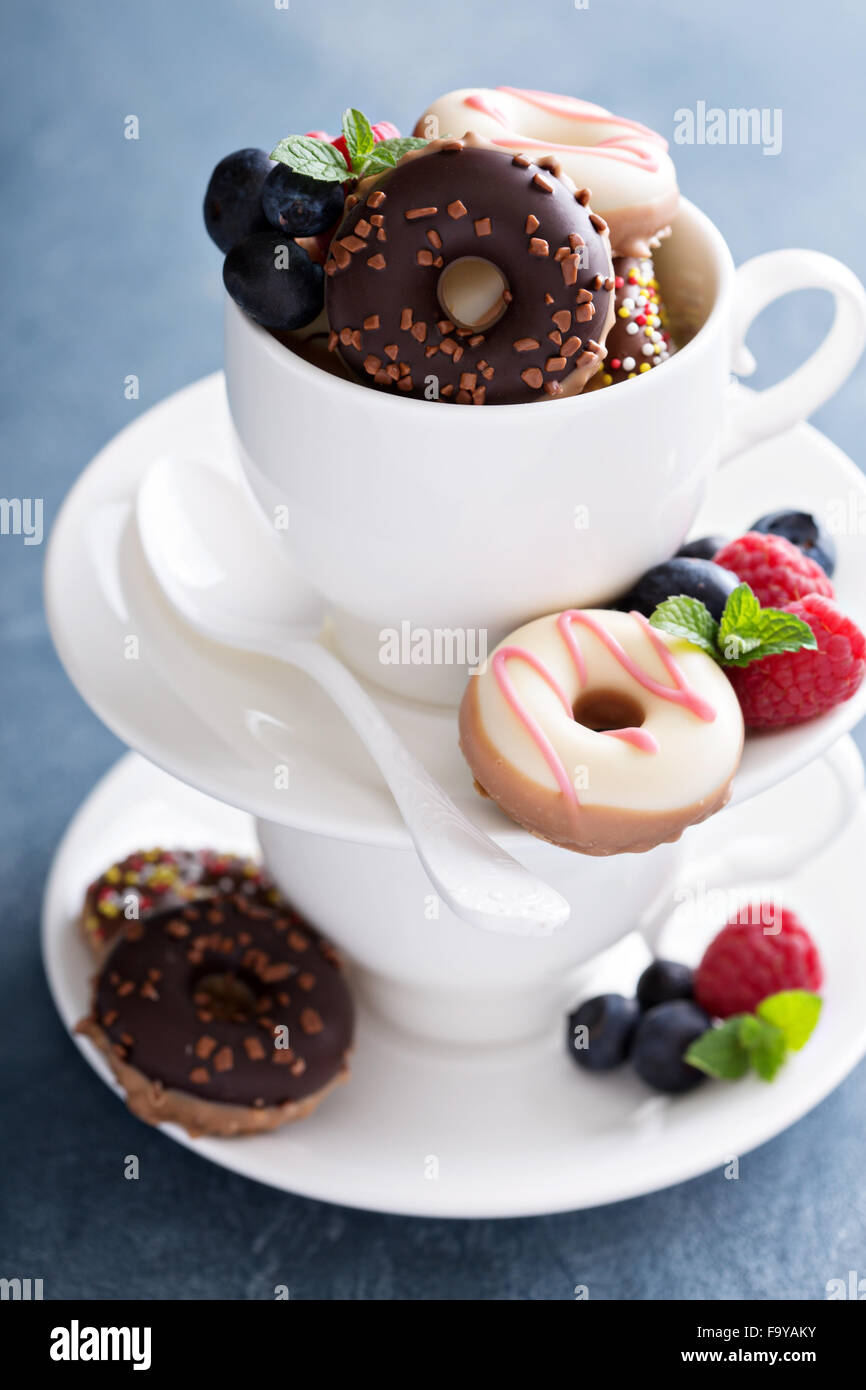Small glazed mini donuts in stacked coffee cups Stock Photo - Alamy