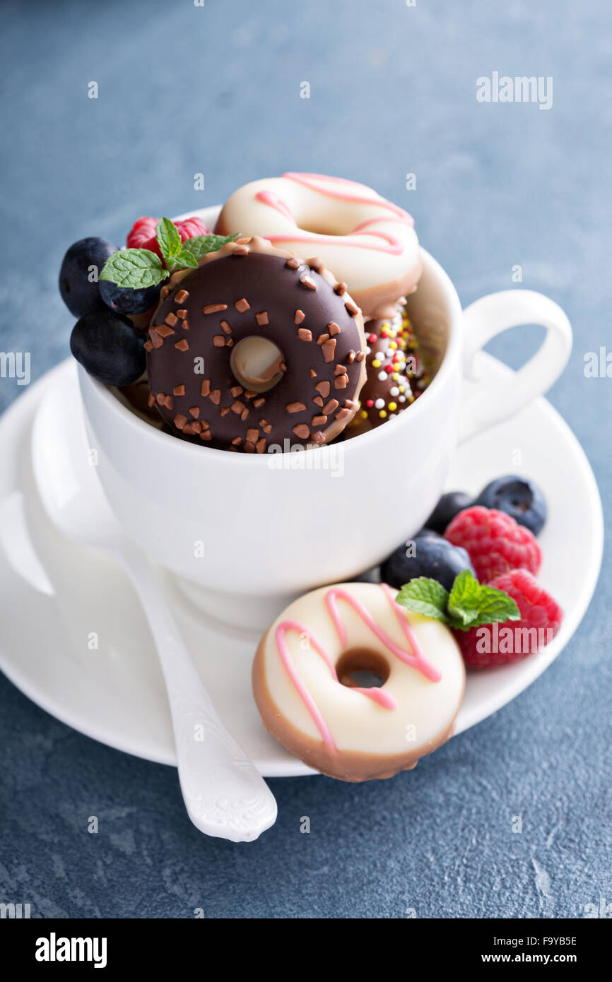 Small glazed mini donuts in stacked coffee cups Stock Photo - Alamy
