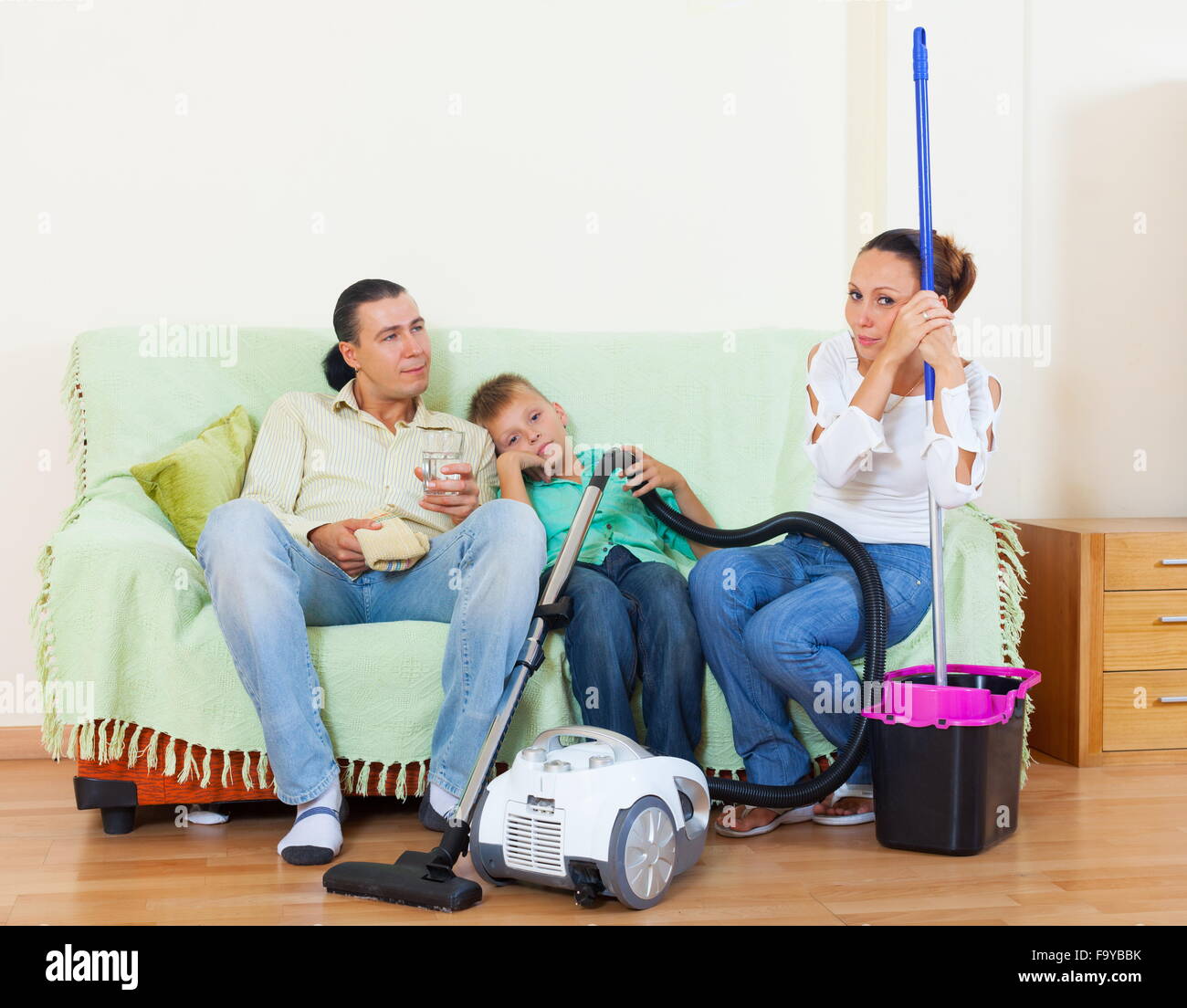 Portrait of tired family, finish cleaning the apartment Stock Photo - Alamy