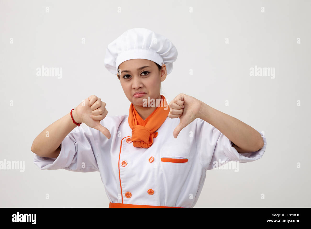 woman chef sad expression with thumb down Stock Photo - Alamy