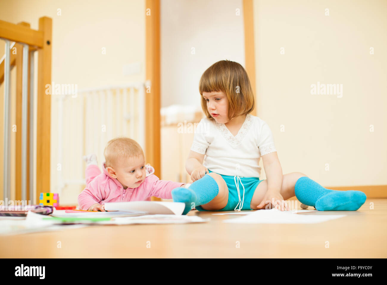 Two children together in home interior Stock Photo - Alamy