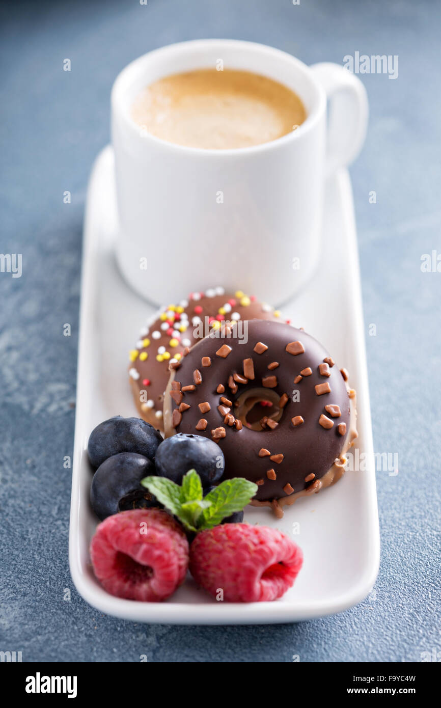 Small glazed mini donuts and coffee in an espresso cup Stock Photo - Alamy