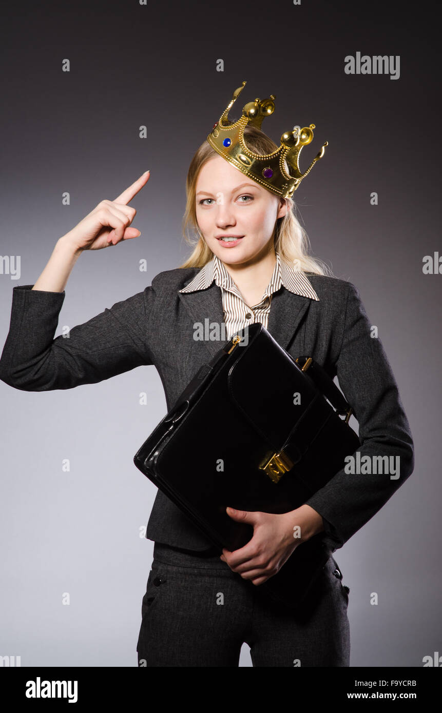 Businesslady wearing crown against gray Stock Photo - Alamy