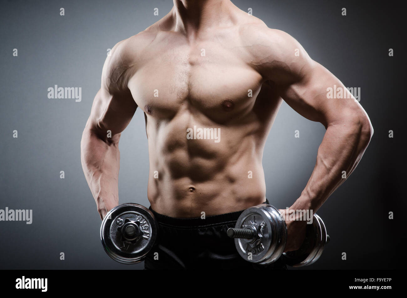 Muscular ripped bodybuilder with dumbbells Stock Photo - Alamy