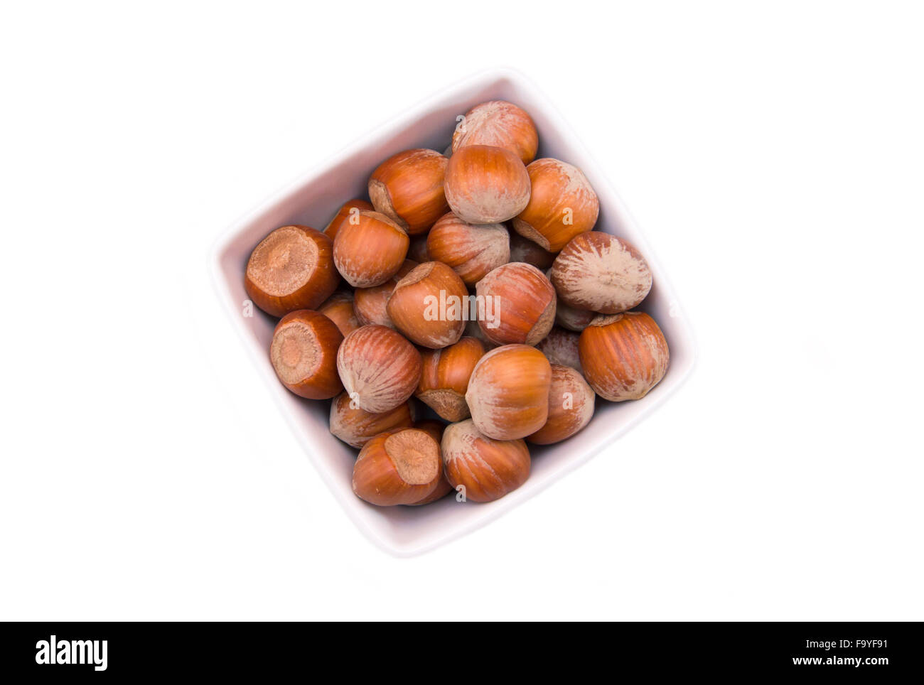 Hazelnuts on square bowl on a white background seen from above Stock ...