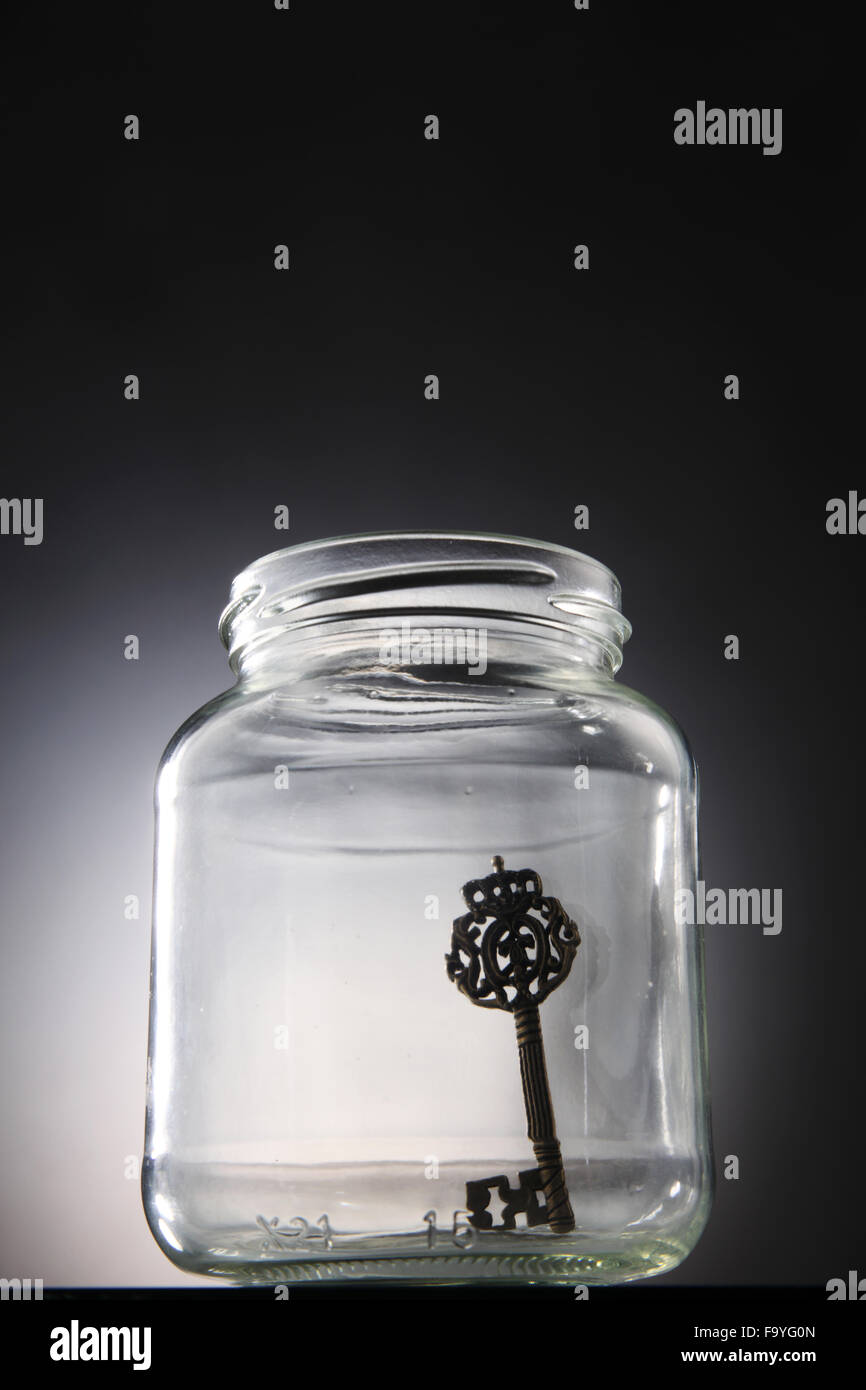 key in a empty jar Stock Photo - Alamy