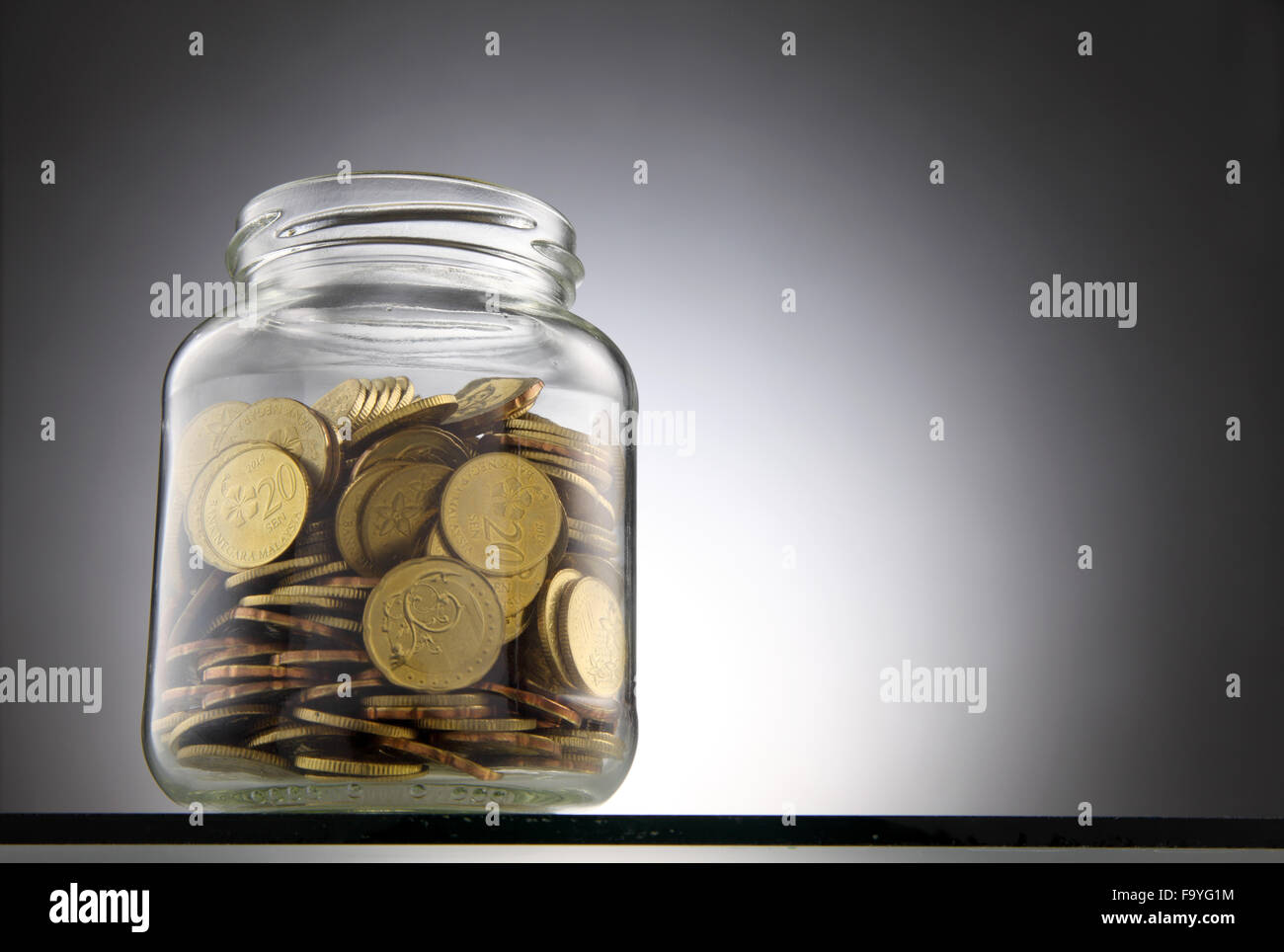money or coins in the saving jar Stock Photo - Alamy
