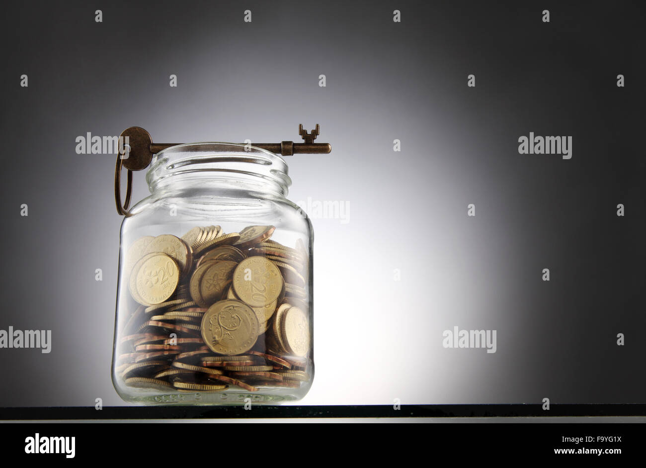 key on top of the saving jar Stock Photo - Alamy