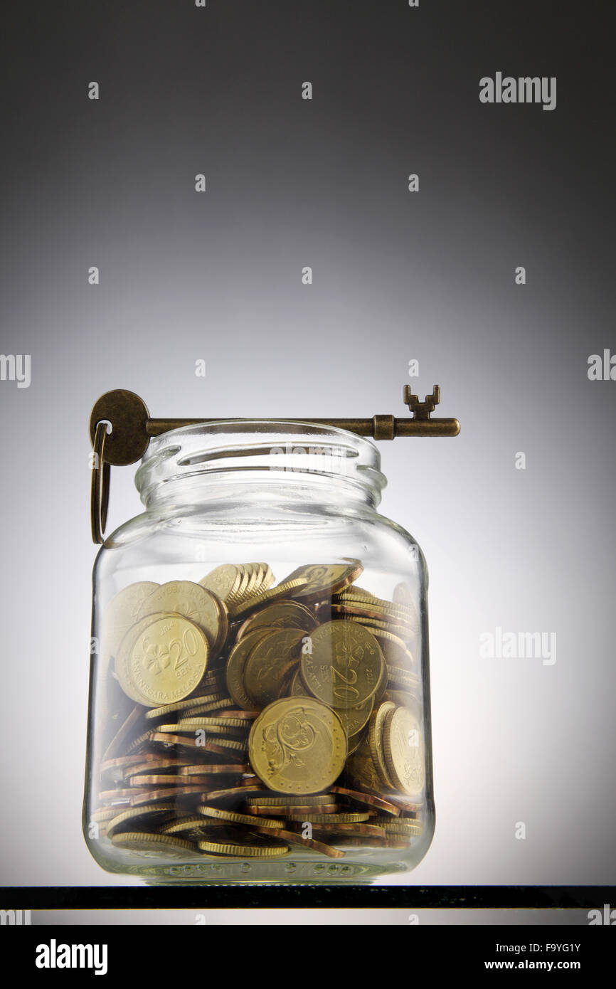key on top of the saving jar Stock Photo - Alamy