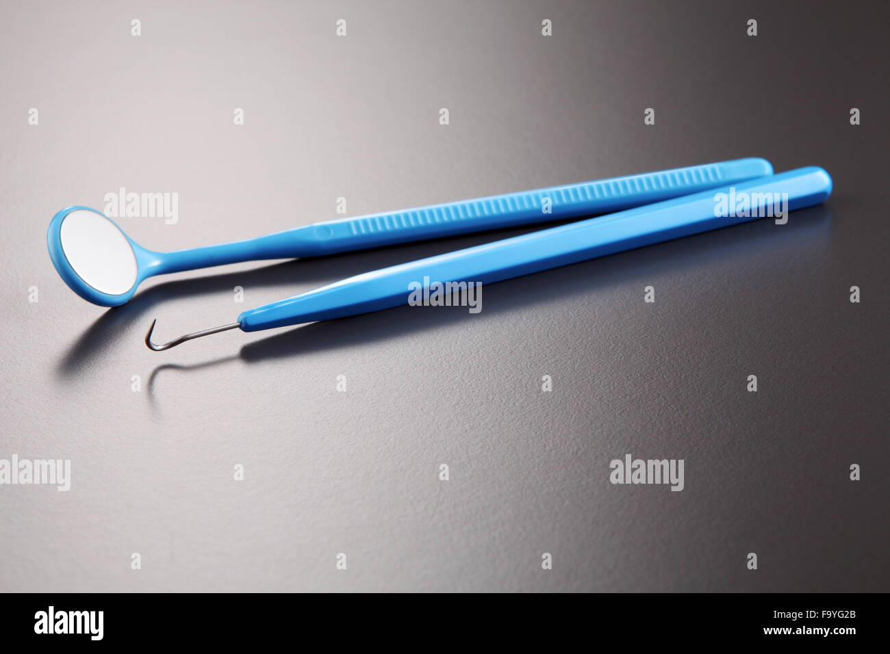 Basic dentist tools isolated on gray Stock Photo - Alamy