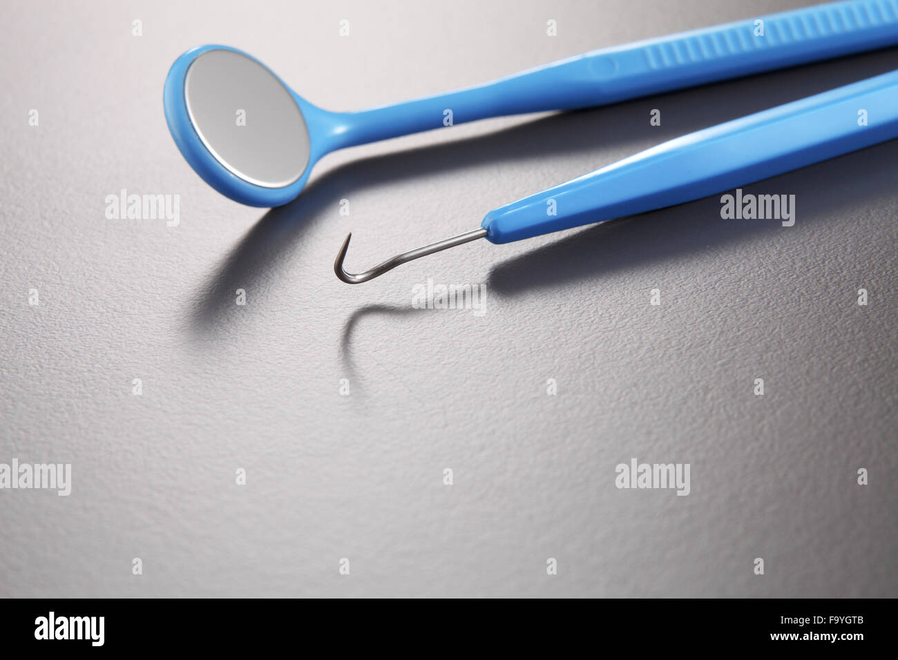 Basic dentist tools isolated on gray Stock Photo - Alamy