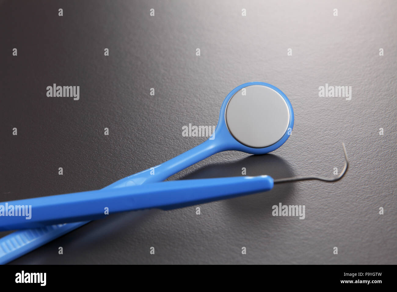 Basic dentist tools isolated on gray Stock Photo - Alamy