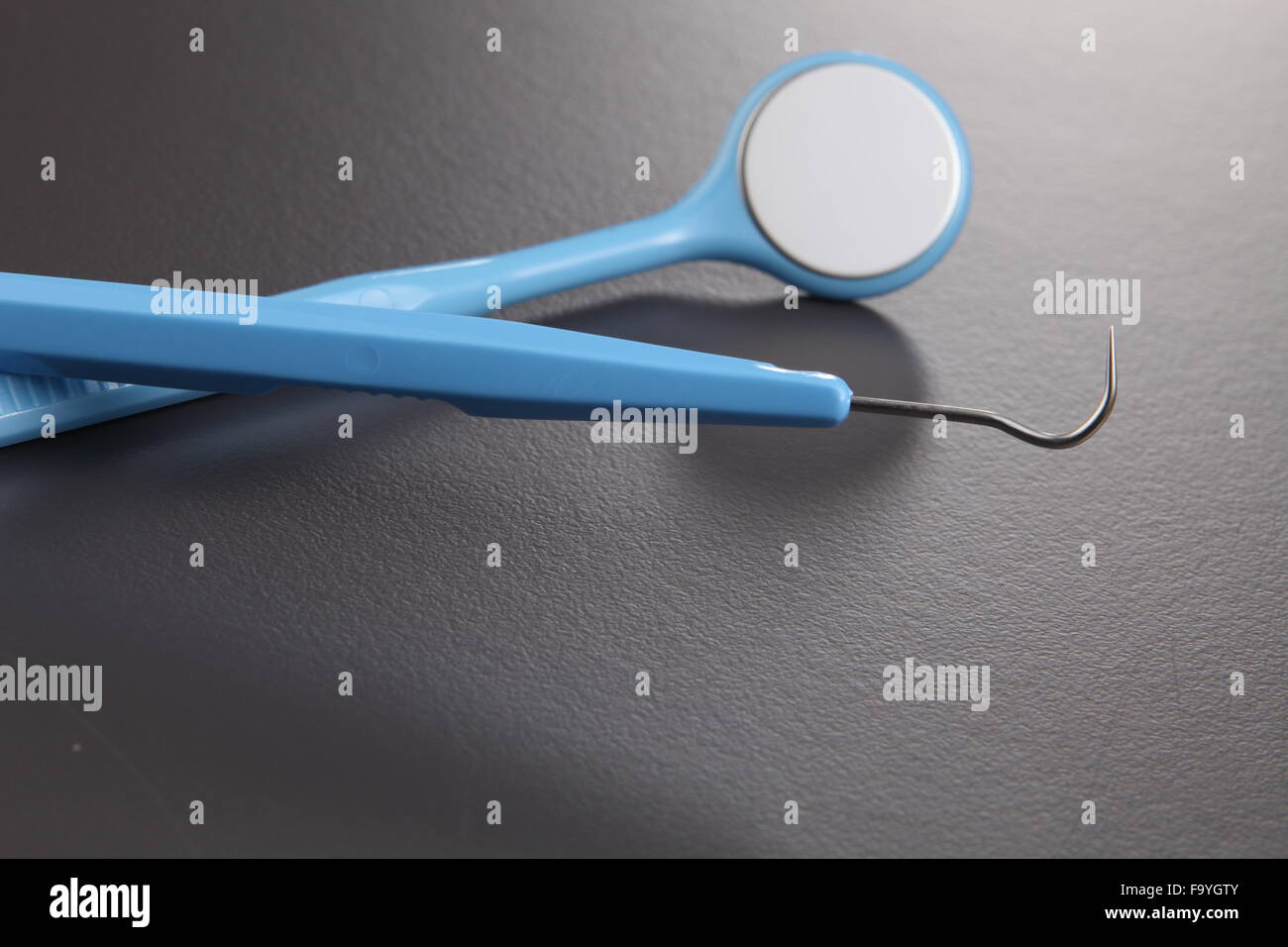 Basic dentist tools isolated on gray Stock Photo - Alamy