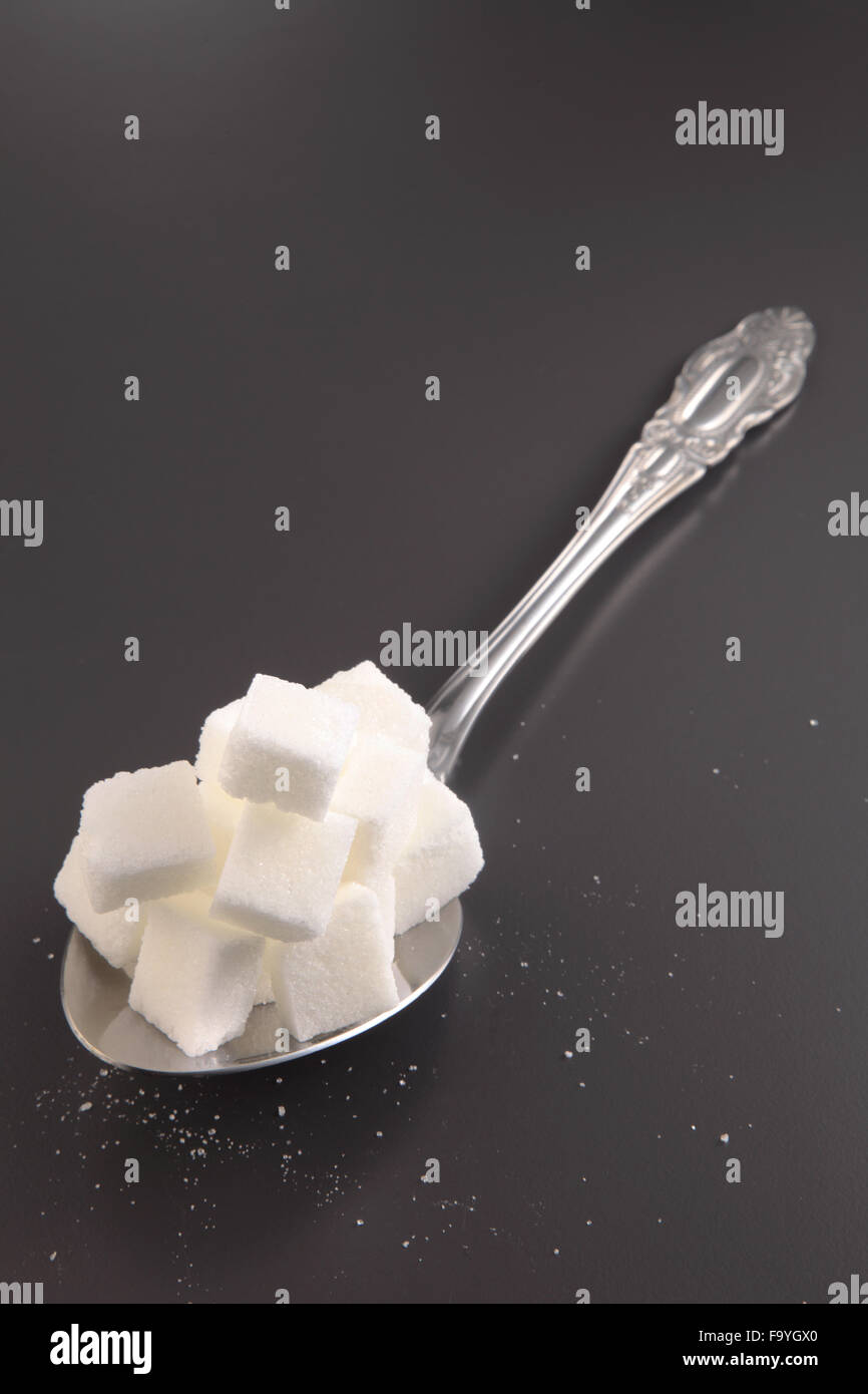 big or super size spoon with pile of cube white sugar Stock Photo - Alamy