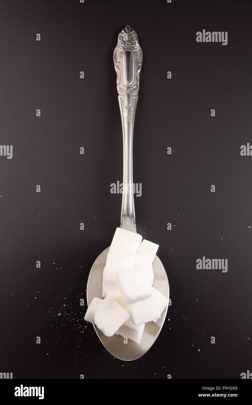 big or super size spoon with pile of cube white sugar Stock Photo - Alamy