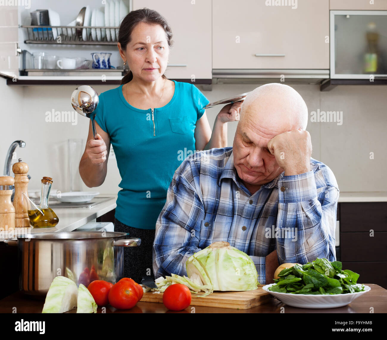 Family conflict. Sad mature man and angry woman during quarrel in ...